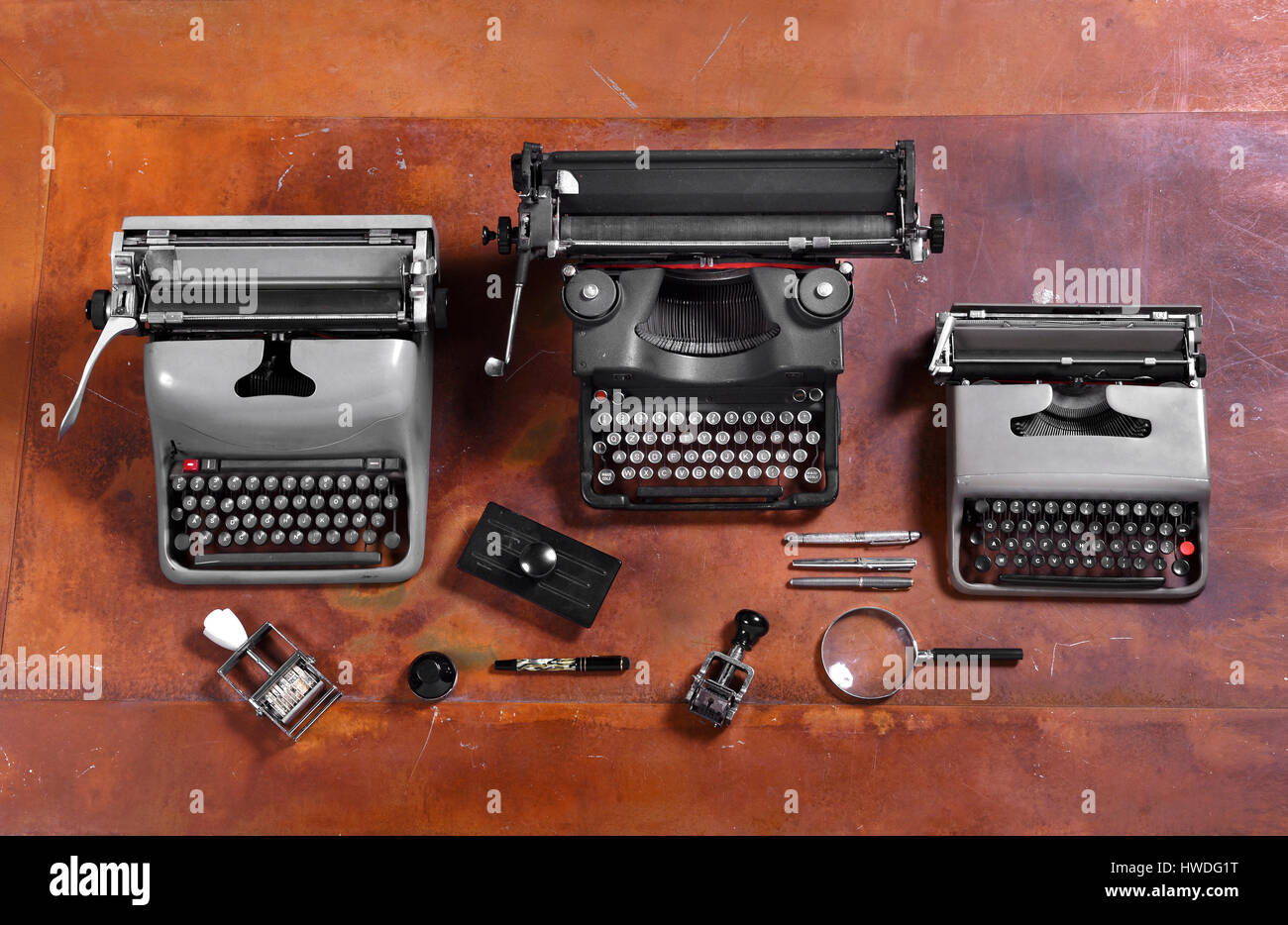 High Angle Still Life View of Three Typewriters with Magnifying Glass ...