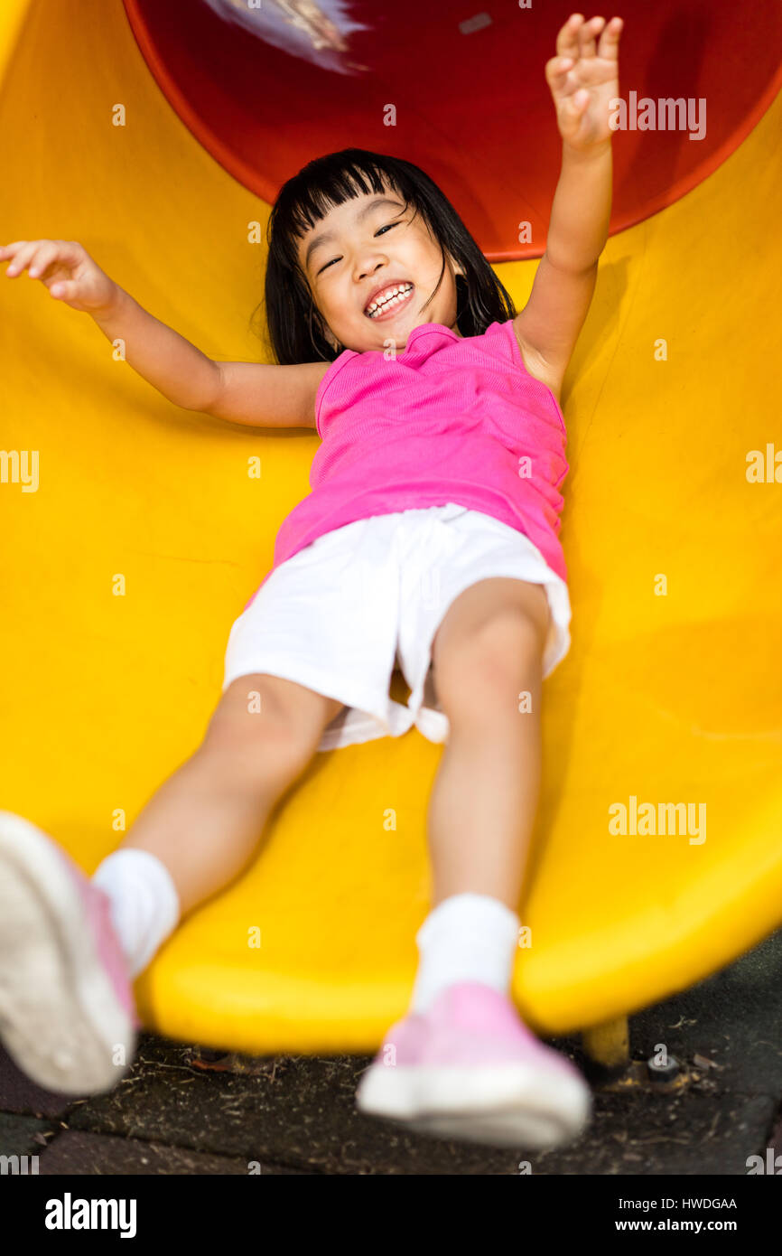 Asian Chinese little girl sliding at outdoor playground Stock Photo - Alamy