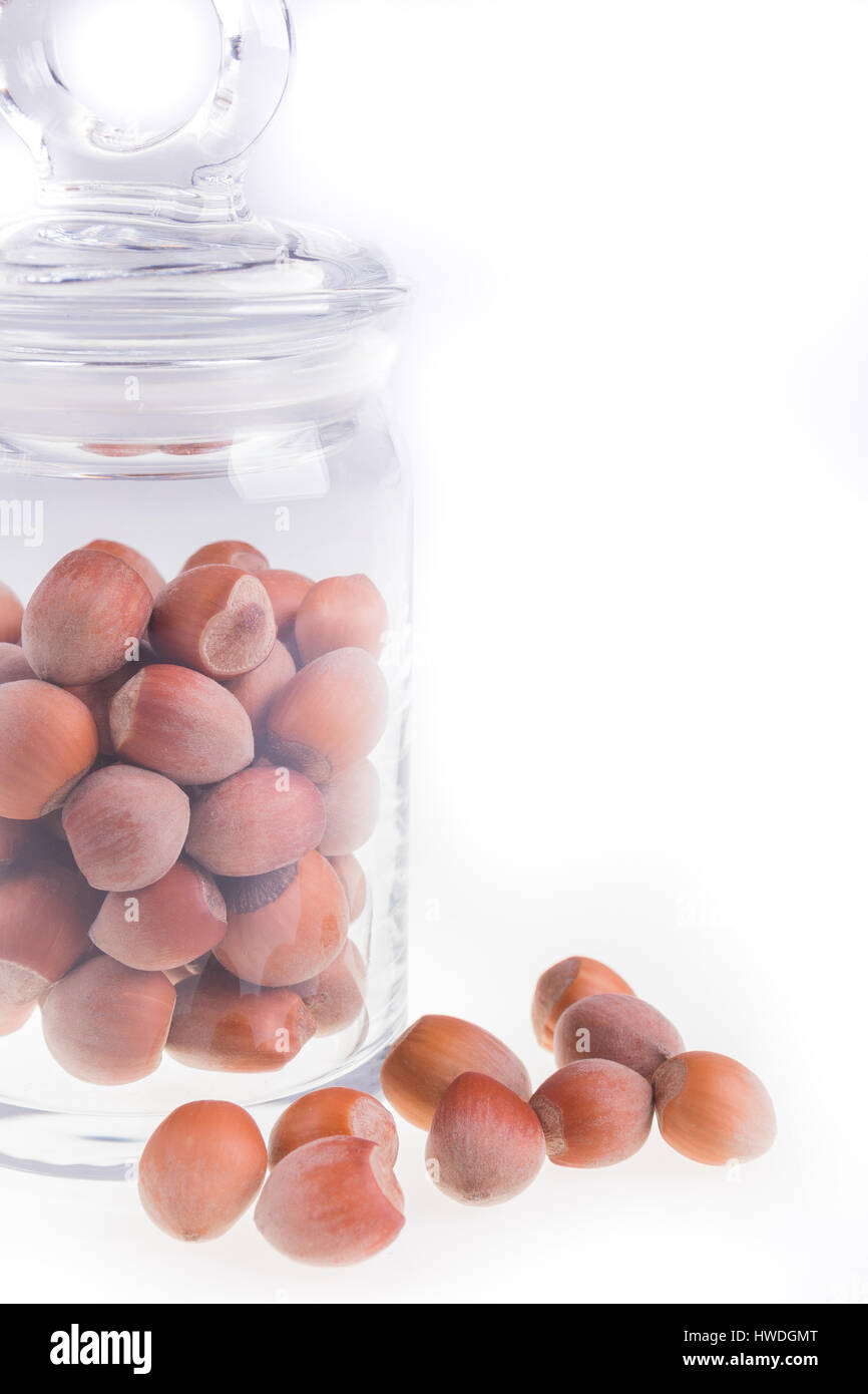 Hazelnuts in glass jar on a white background. Isolated. Dried nuts ...