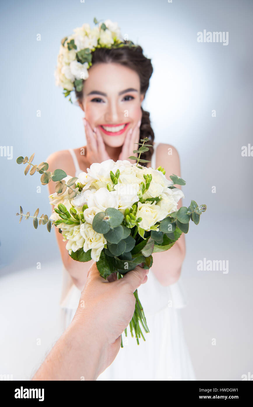 portrait of surprised woman receiving flowers bouquet on white Stock ...