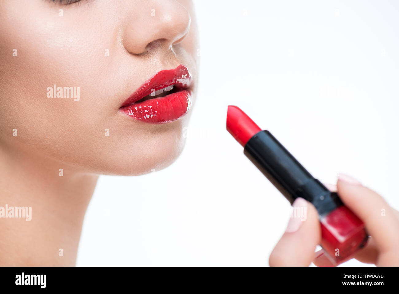 partial view of female lips and lipstick on white Stock Photo - Alamy