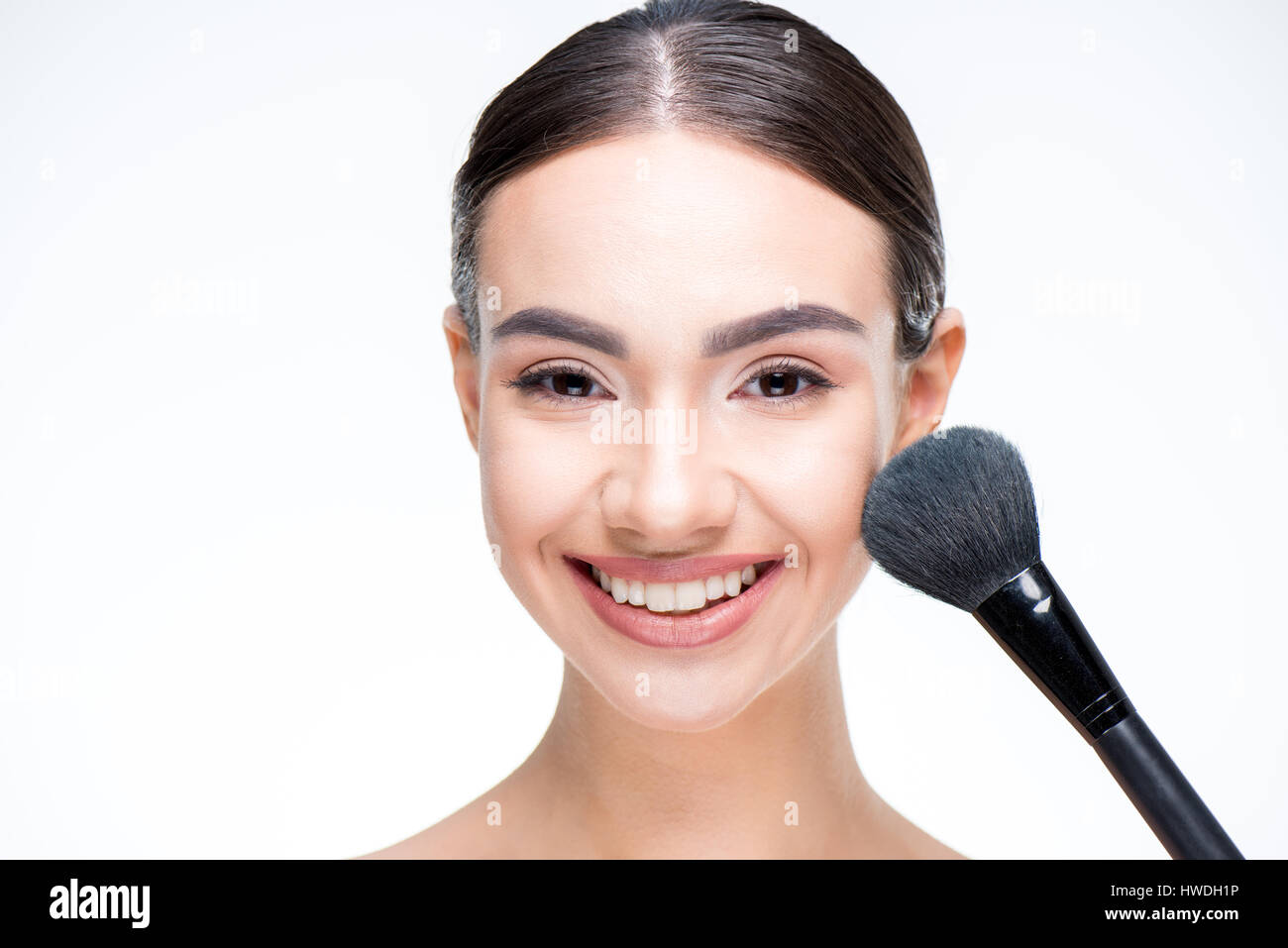 Portrait of beautiful woman powder face with brush isolated on white ...