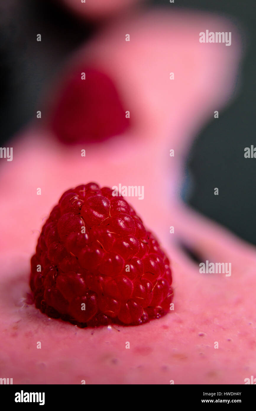 Spilled raspberry smoothie on black table near berry. Close up Stock ...