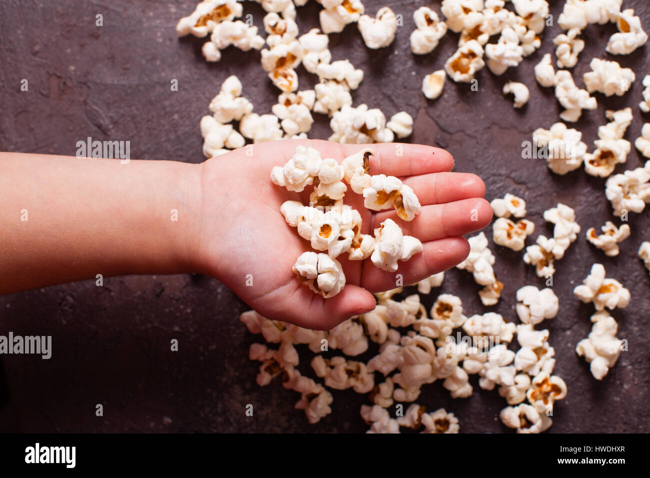Children's hand holds popcorn Stock Photo - Alamy