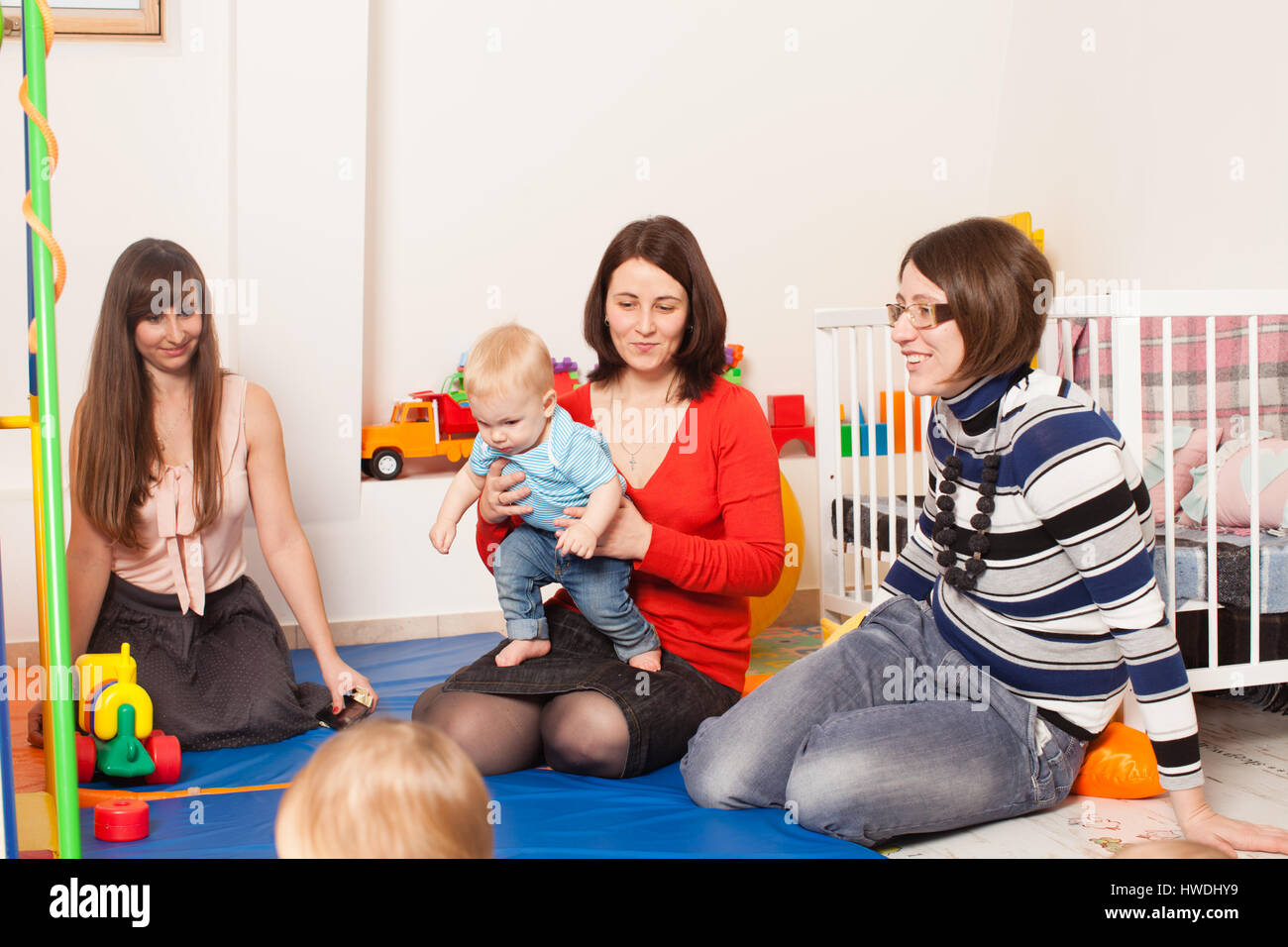 Group of mothers with their babies Stock Photo - Alamy