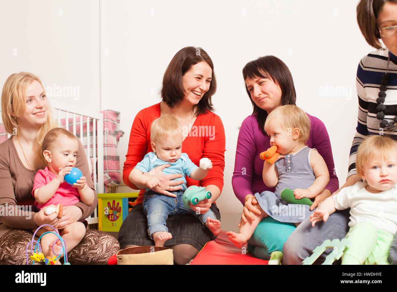 Group of mothers with their babies Stock Photo - Alamy