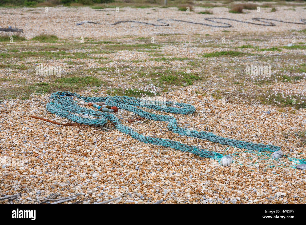 Length of discarded blue plaited rope laid out as an unusual decoration ...