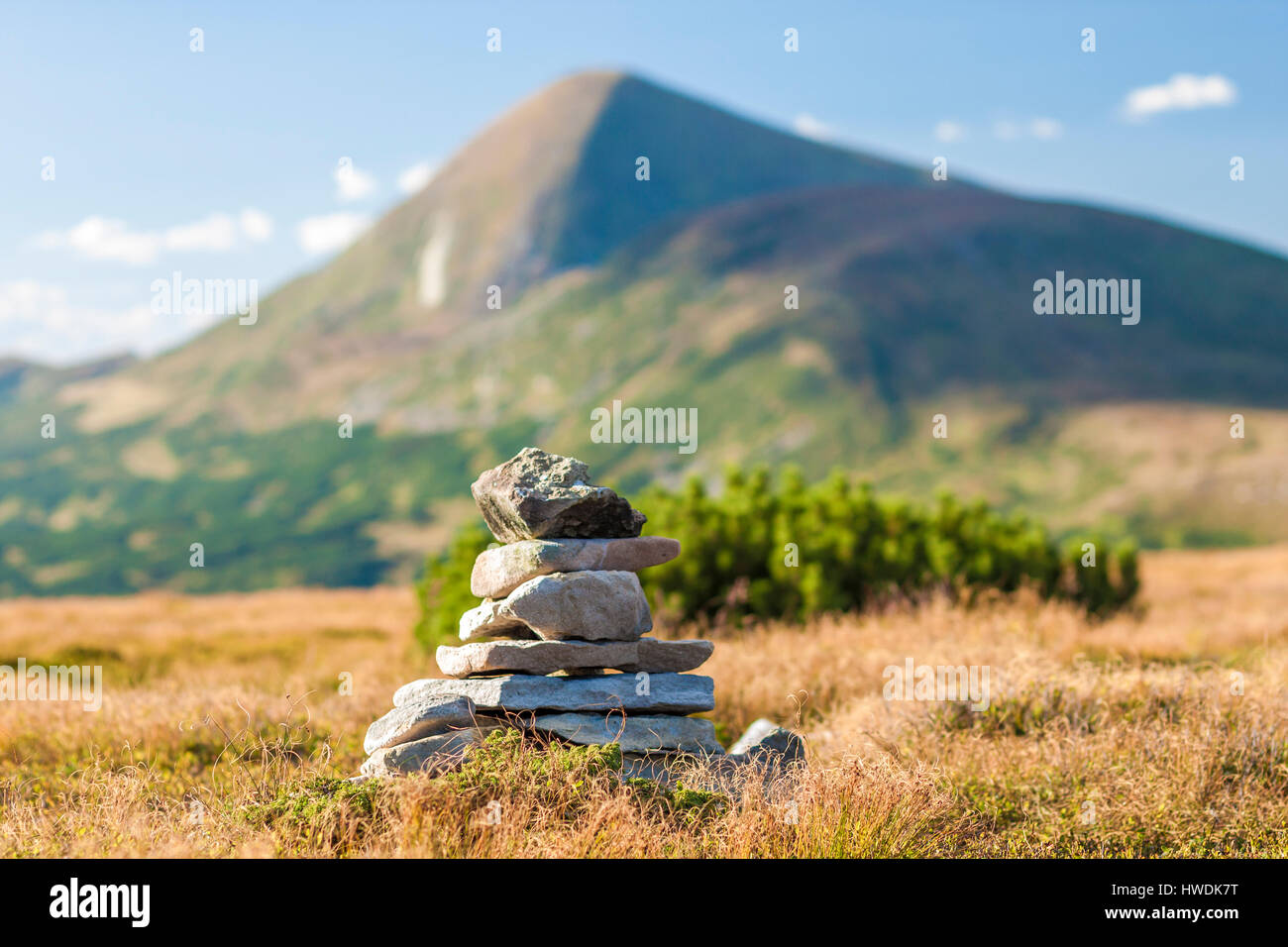 Stack of zen stones overlooking the top of mountain. Concept of balance ...