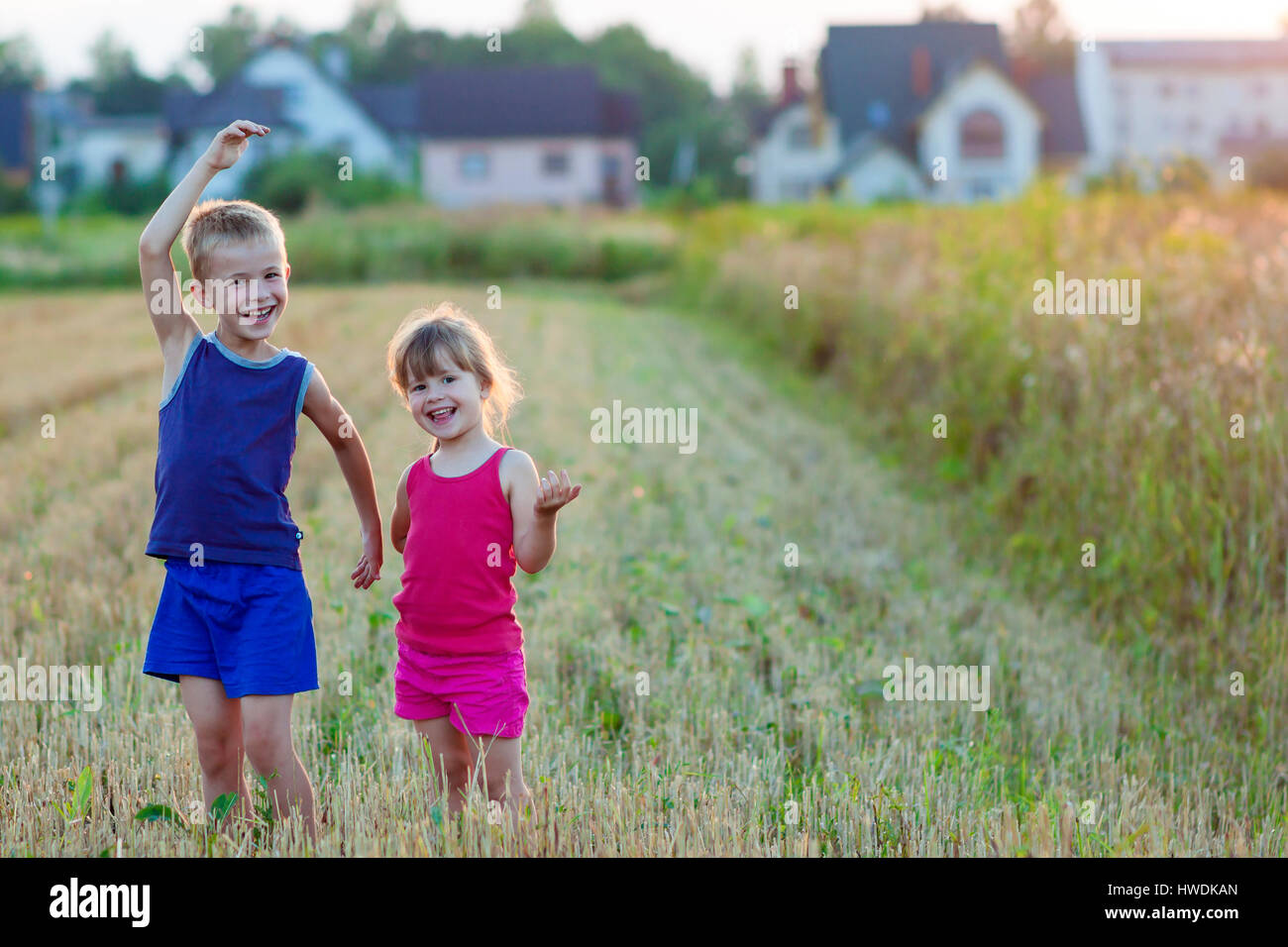 Two happy joyful merry children boy and girl brother and sister ...