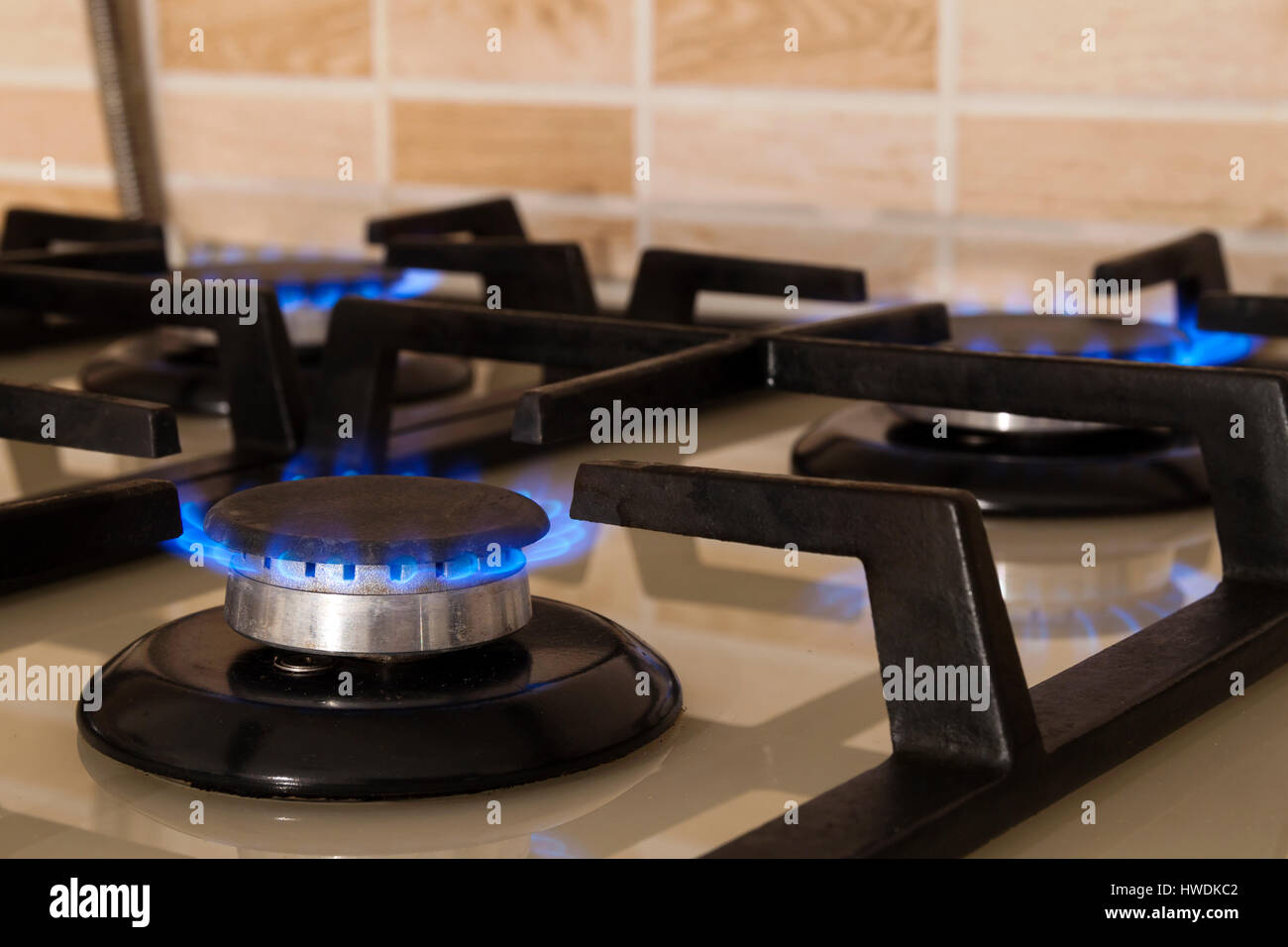 Closeup shot of blue fire from domestic kitchen stove. Gas cooker with ...