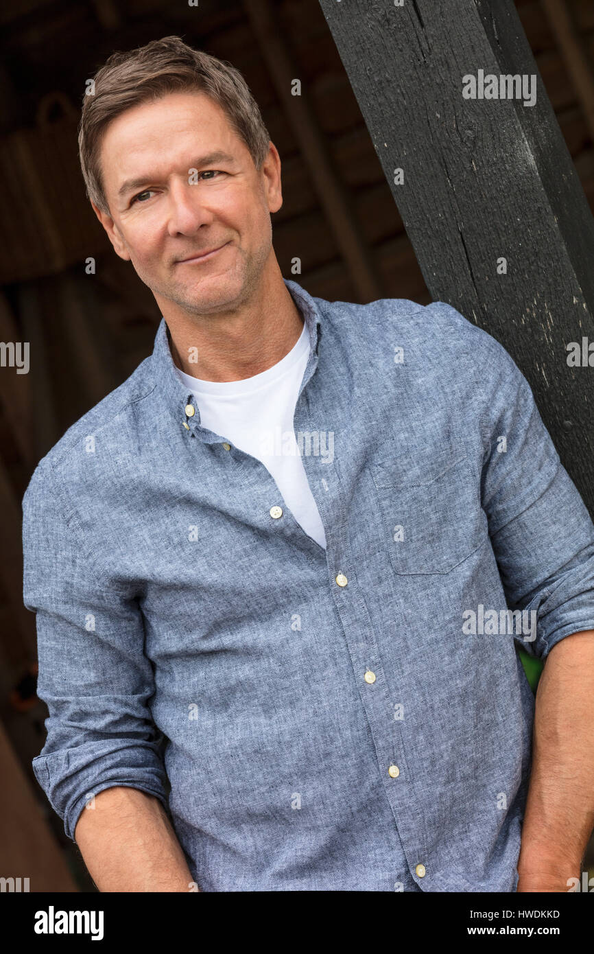 Portrait shot of an attractive, successful and happy middle aged man ...