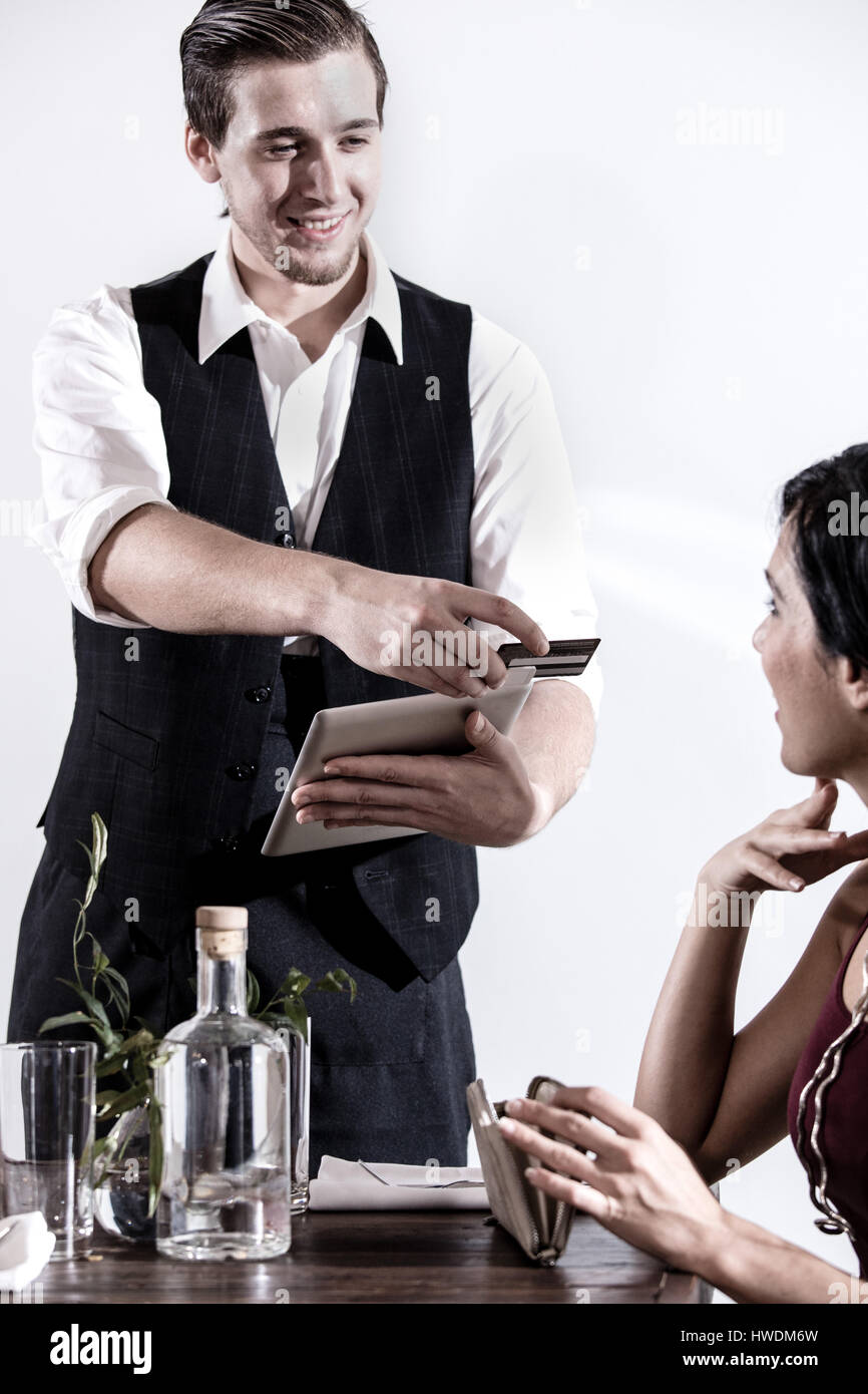 Waiter serving diner in restaurant, waiter using digital tablet Stock ...