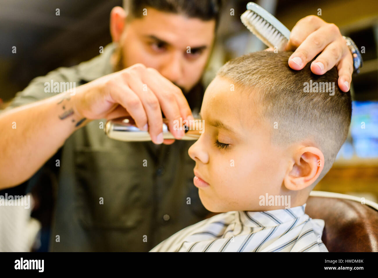 Barber shaving boy's hair Stock Photo - Alamy
