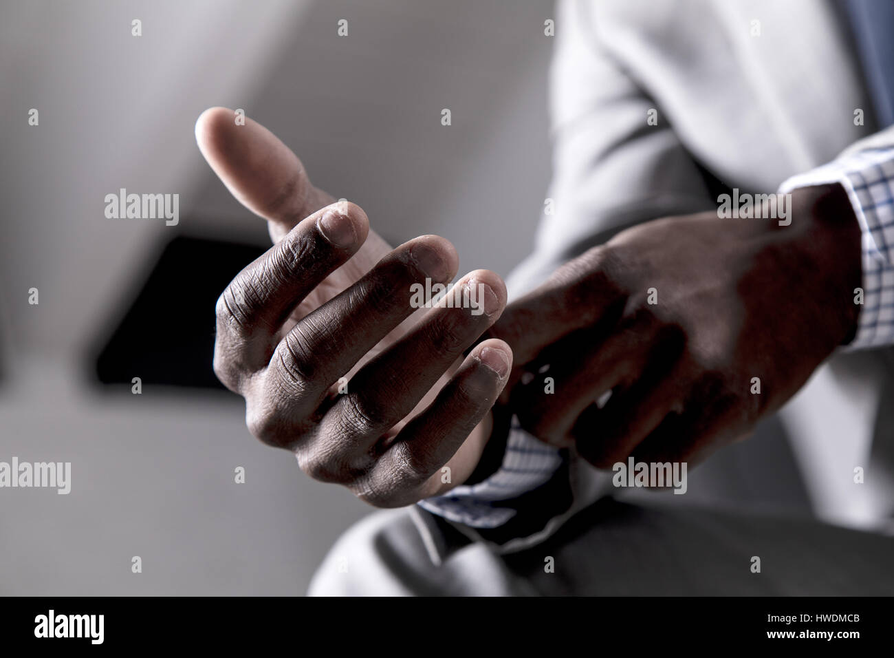 Young man buttoning shirt cuff, close-up Stock Photo - Alamy