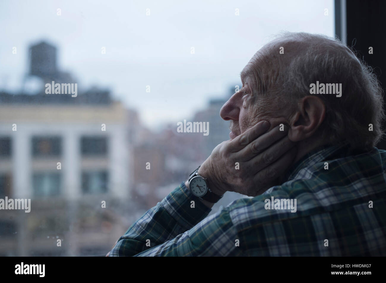 Man looking out of window, Manhattan, New York, USA Stock Photo - Alamy