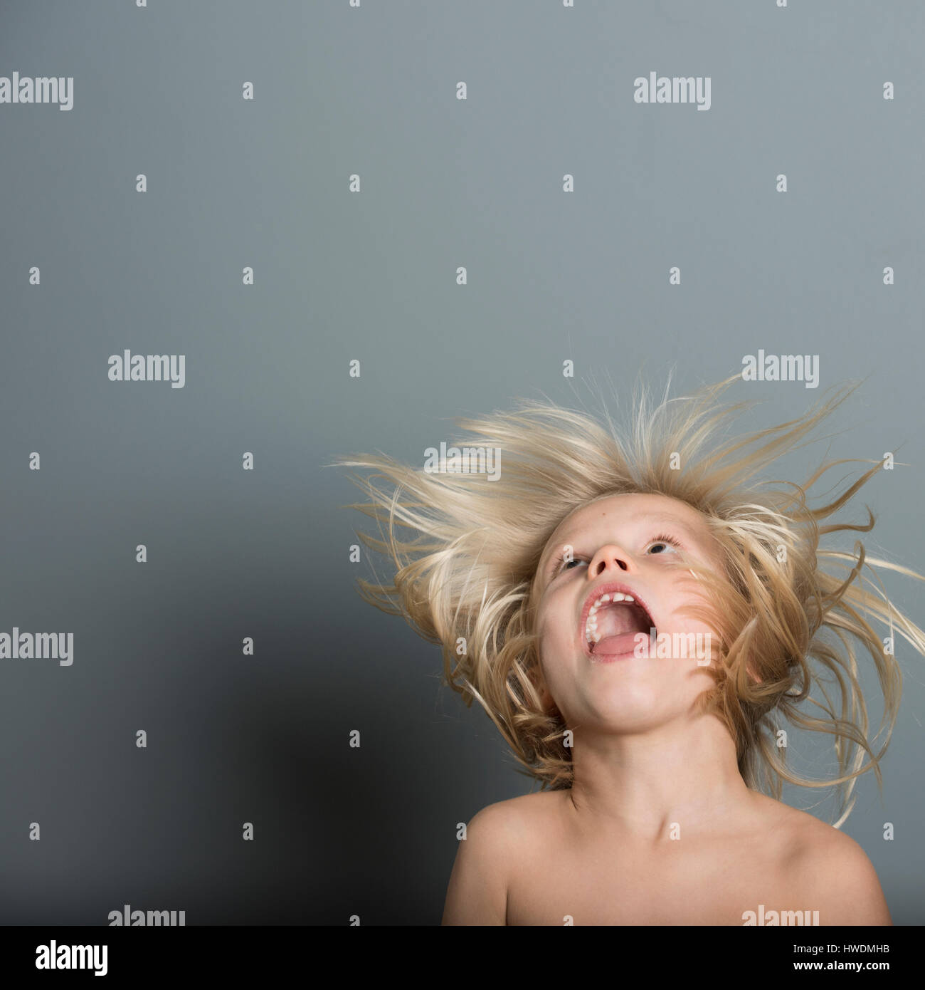 Portrait of boy throwing hair back Stock Photo - Alamy