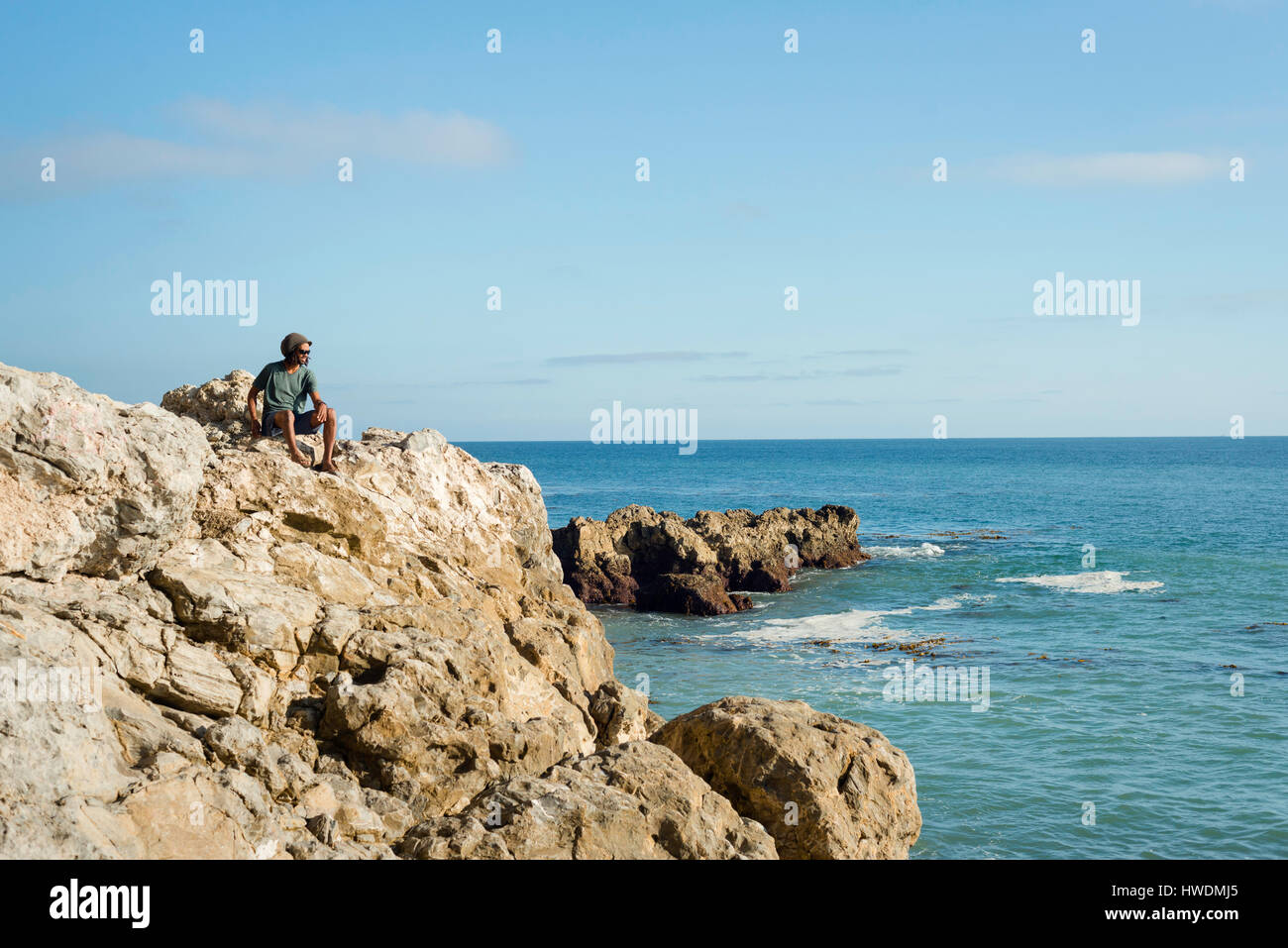 Man sitting on rock looking hi-res stock photography and images - Alamy