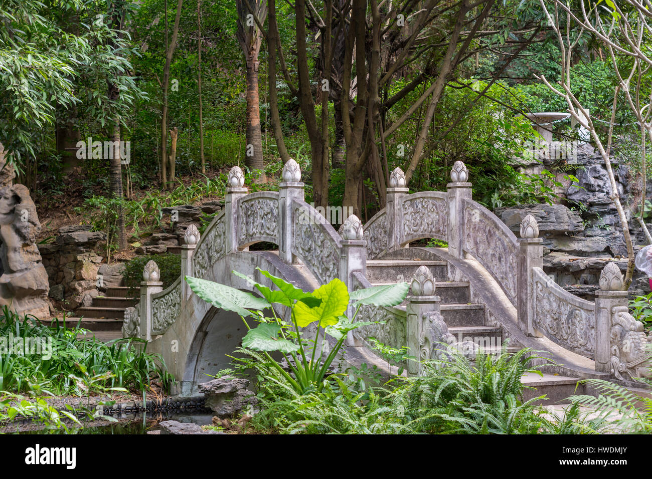 Stone bridge in a Chinese style garden Stock Photo - Alamy