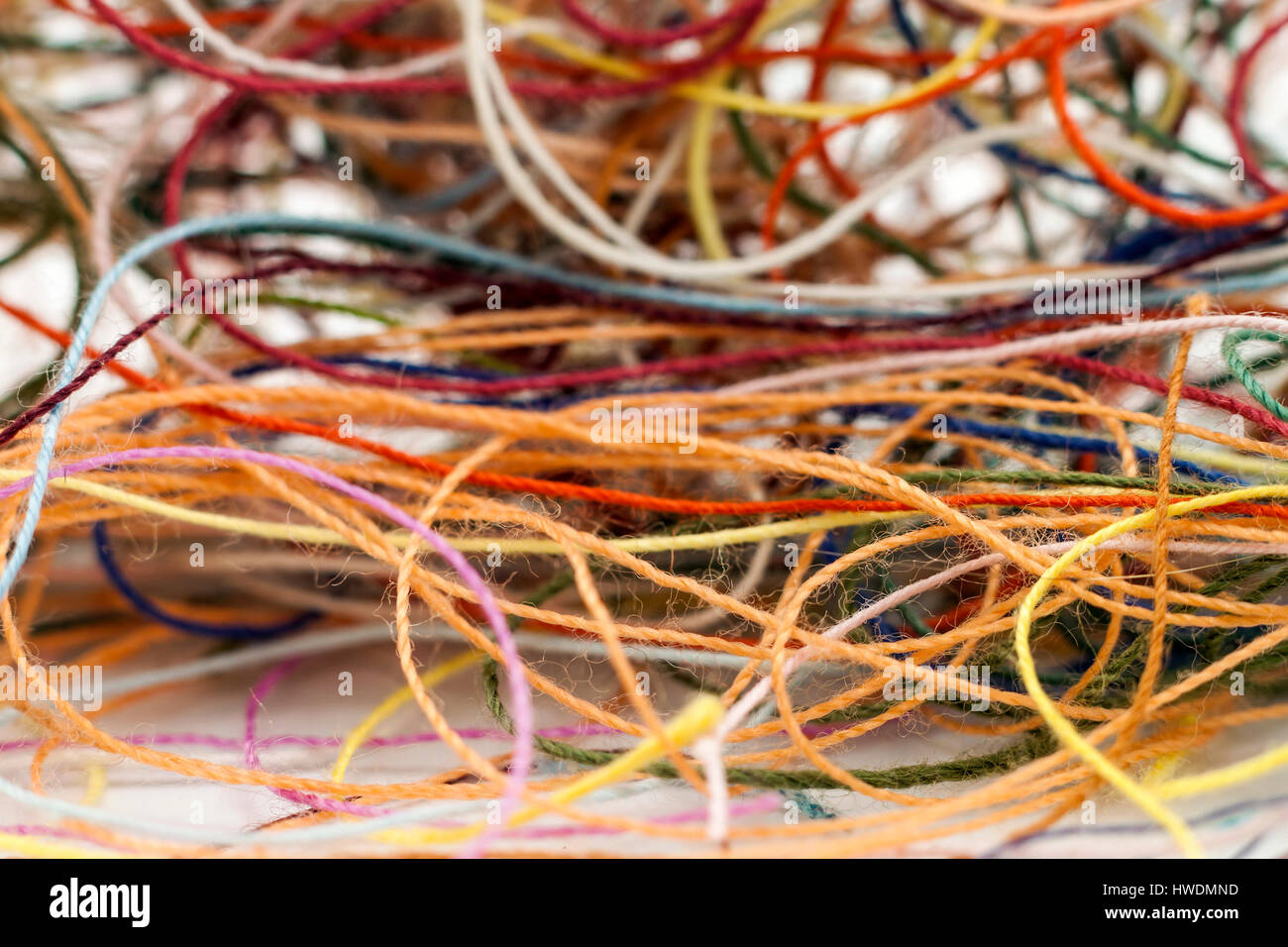 Multi-colored tangled colorful needlecraft silk thread rope. Macro shot ...