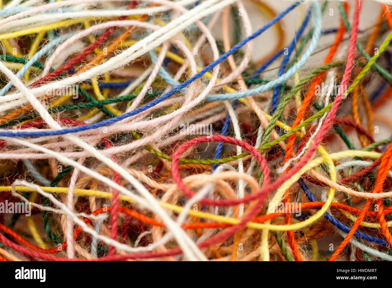 Multi-colored tangled colorful needlecraft silk thread rope. Macro shot ...