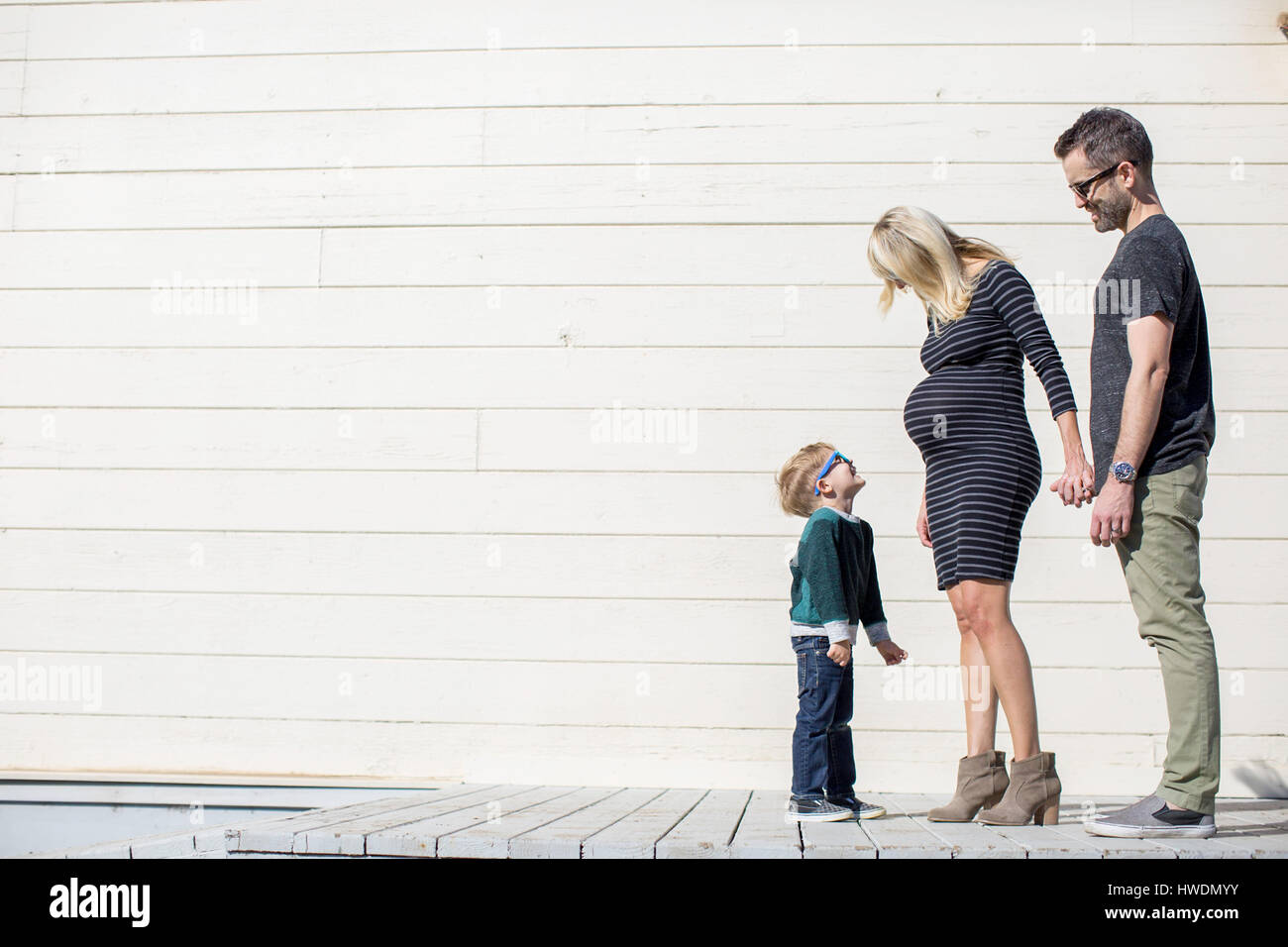 Woman standing beside building hi-res stock photography and images - Alamy