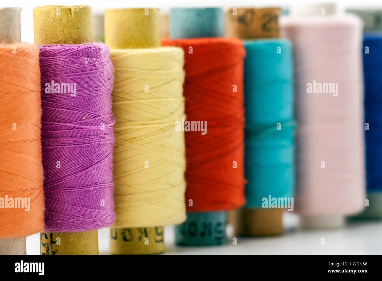 Reels or spools of multicolored sewing threads. Threads of all colors ...