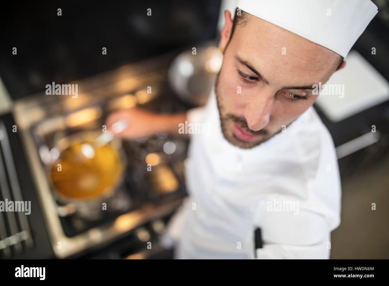 Chef stirring stove hi-res stock photography and images - Alamy