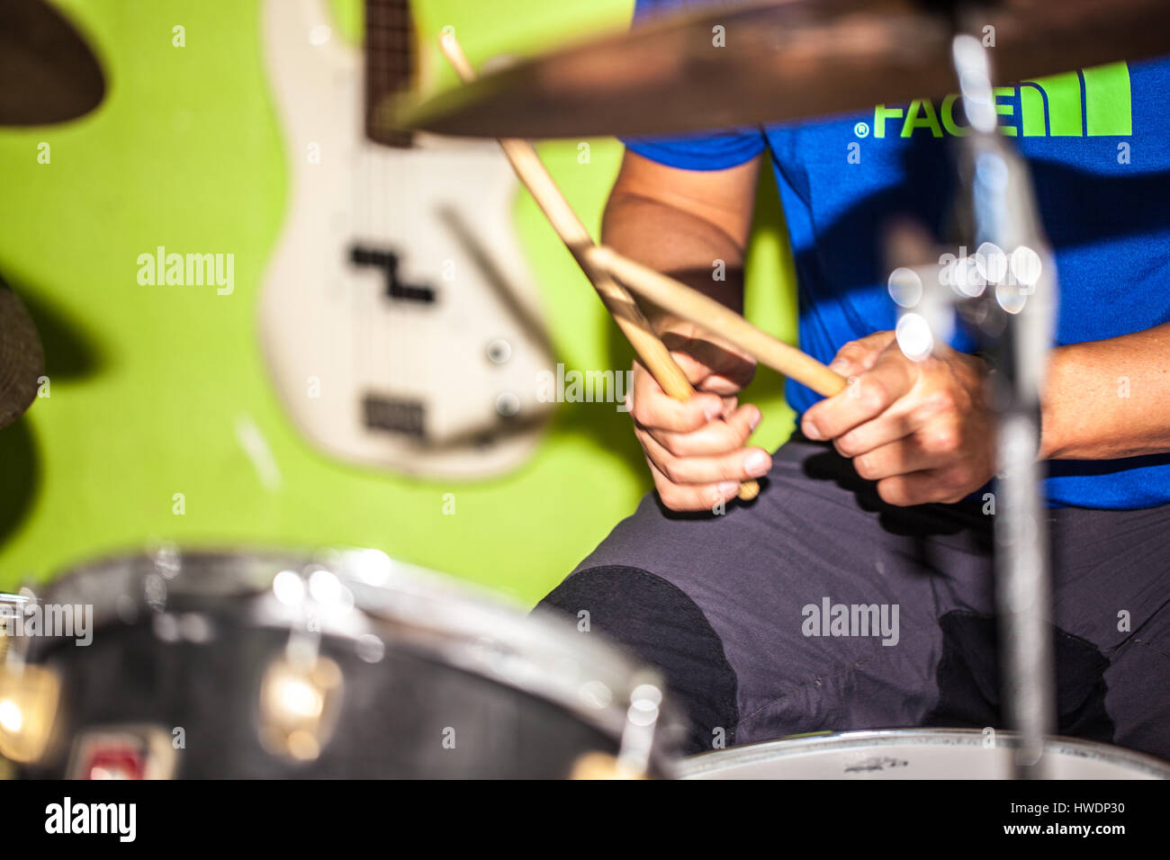 young man playing the drums in a room Stock Photo - Alamy