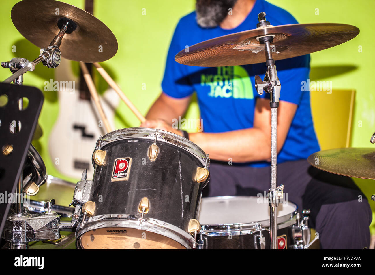 young man playing the drums in a room Stock Photo - Alamy