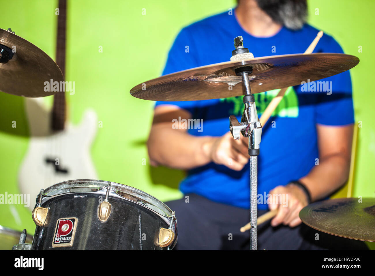 young man playing the drums in a room Stock Photo - Alamy