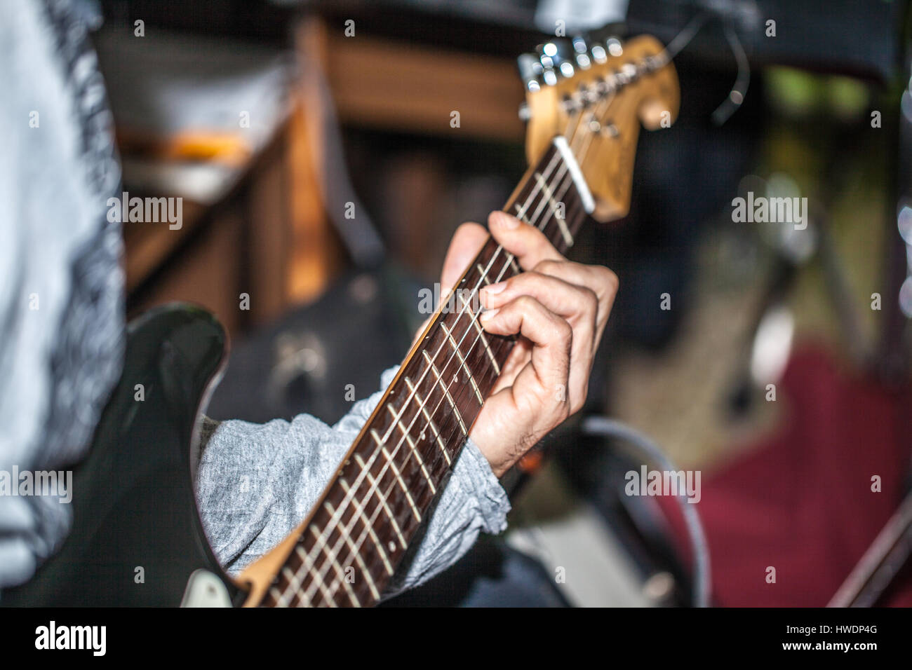 young man playing an electric guitar Stock Photo - Alamy
