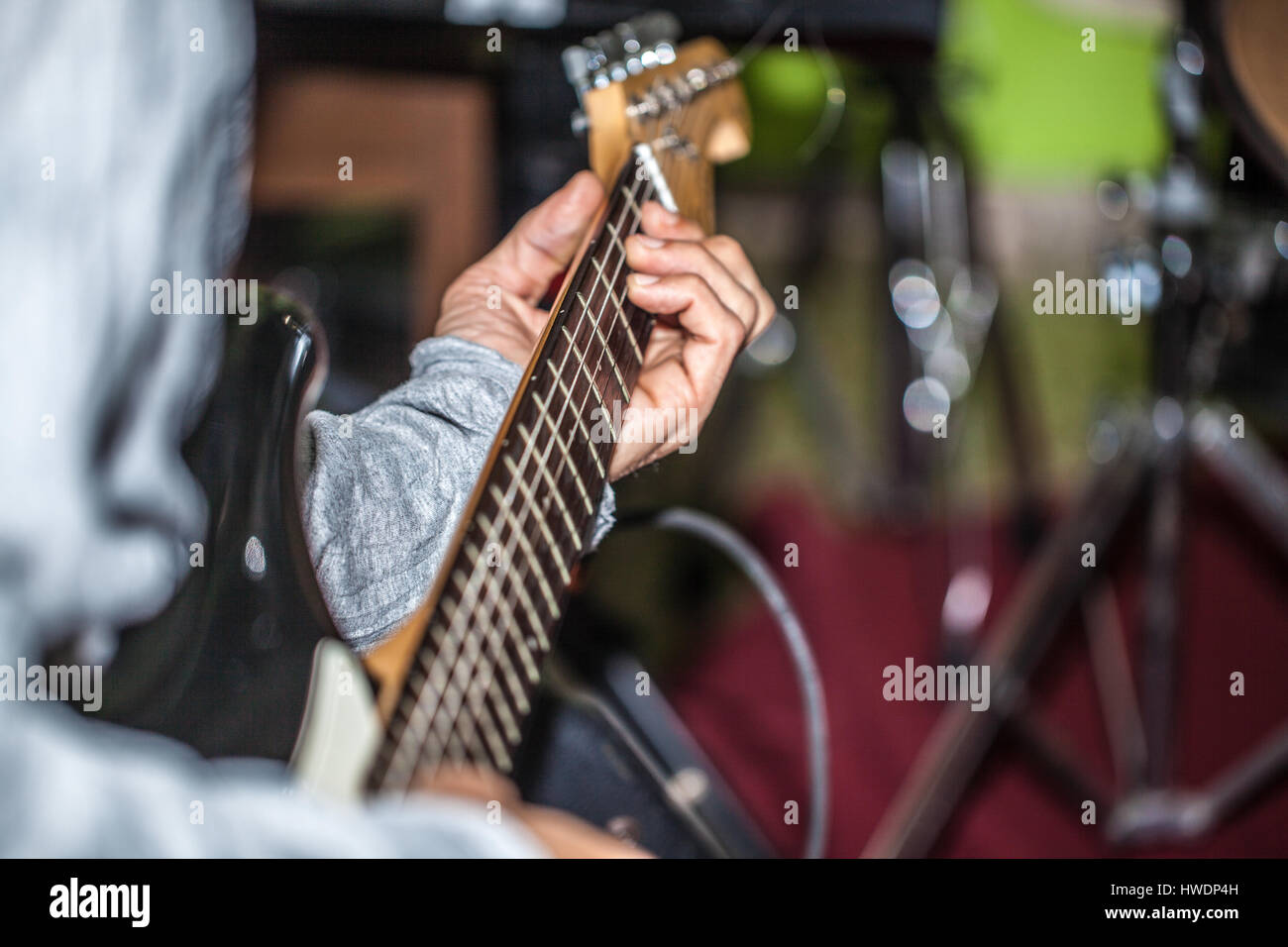 young man playing an electric guitar Stock Photo - Alamy