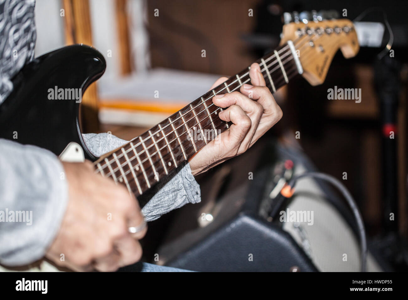 young man playing an electric guitar Stock Photo - Alamy