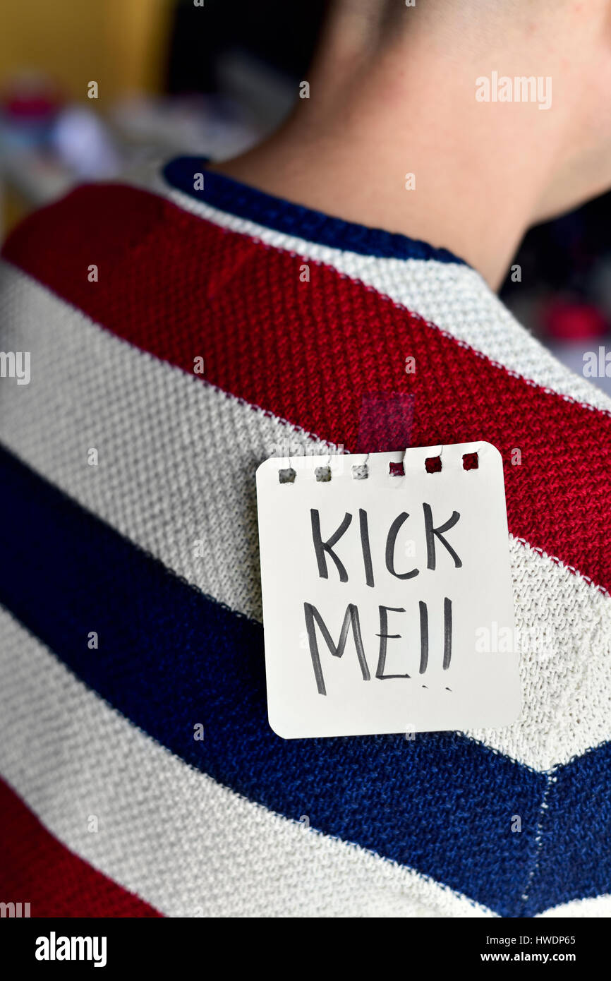 closeup of a young caucasian man seen from behind sitting to his office ...