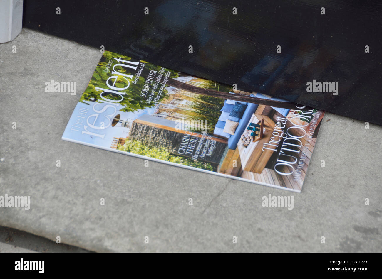 Free magazine under street door Stock Photo - Alamy