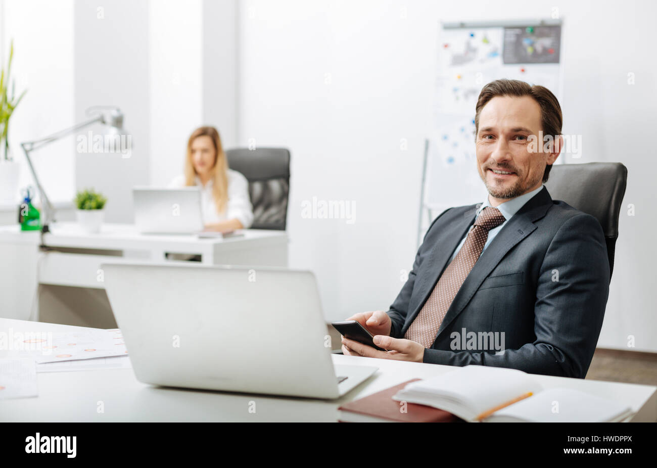 Smiling executive enjoying working hours in the office Stock Photo - Alamy