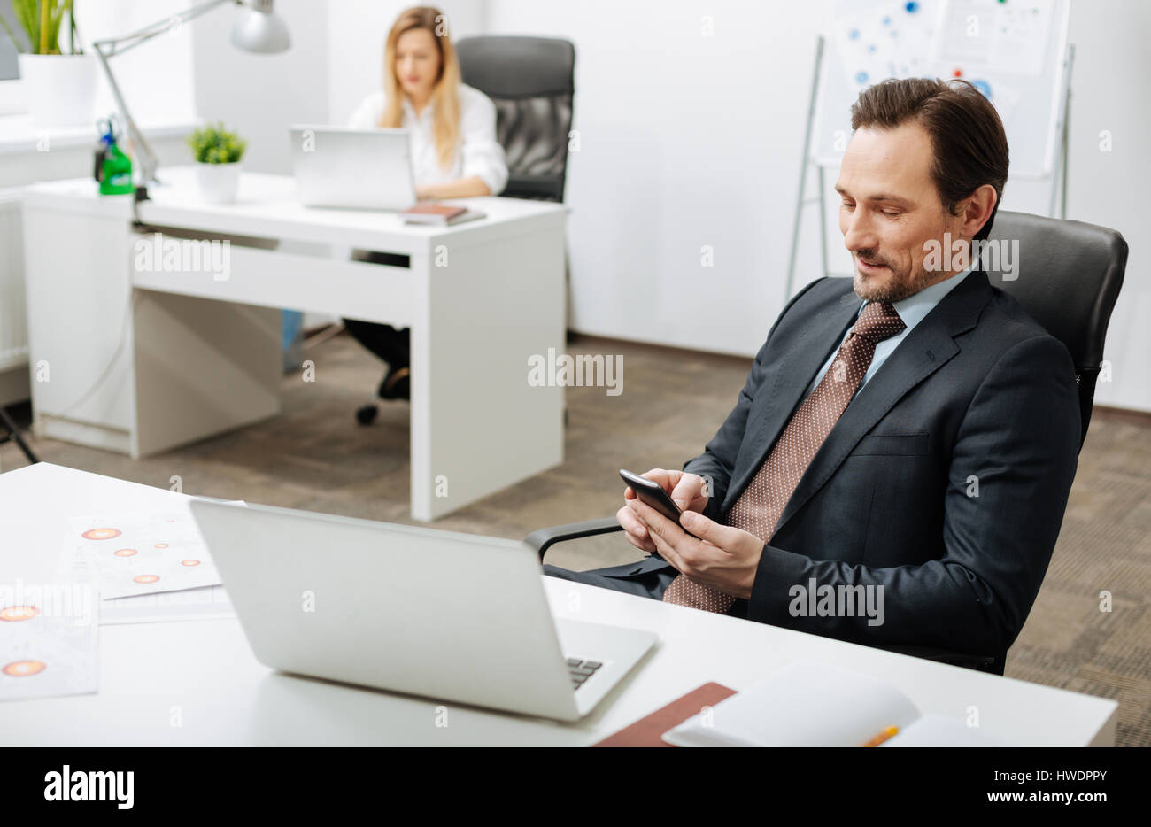 Cheerful executive enjoying new gadget in the office Stock Photo - Alamy