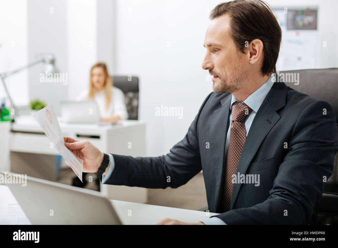 Concentrated executive reading important documents in the office Stock ...