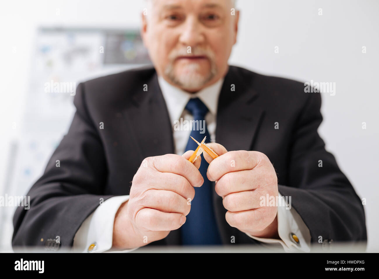 Angry powerful businessman breaking pencil in the office Stock Photo ...