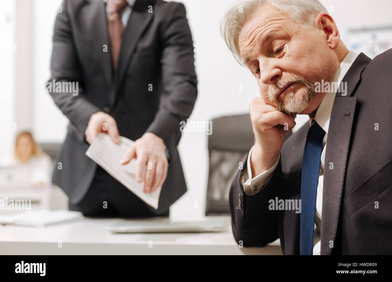 Indifferent employer expressing apathy in the office Stock Photo - Alamy