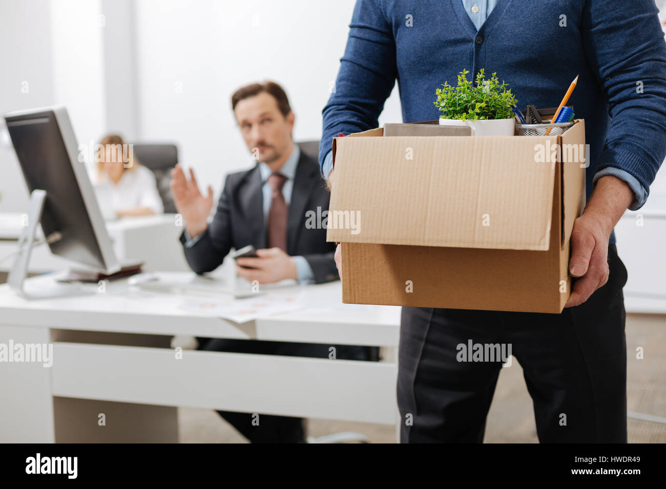 Fired senior employee leaving the office with the box Stock Photo - Alamy