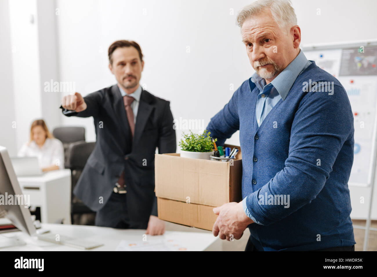 Confident employer firing the employee from the company Stock Photo - Alamy