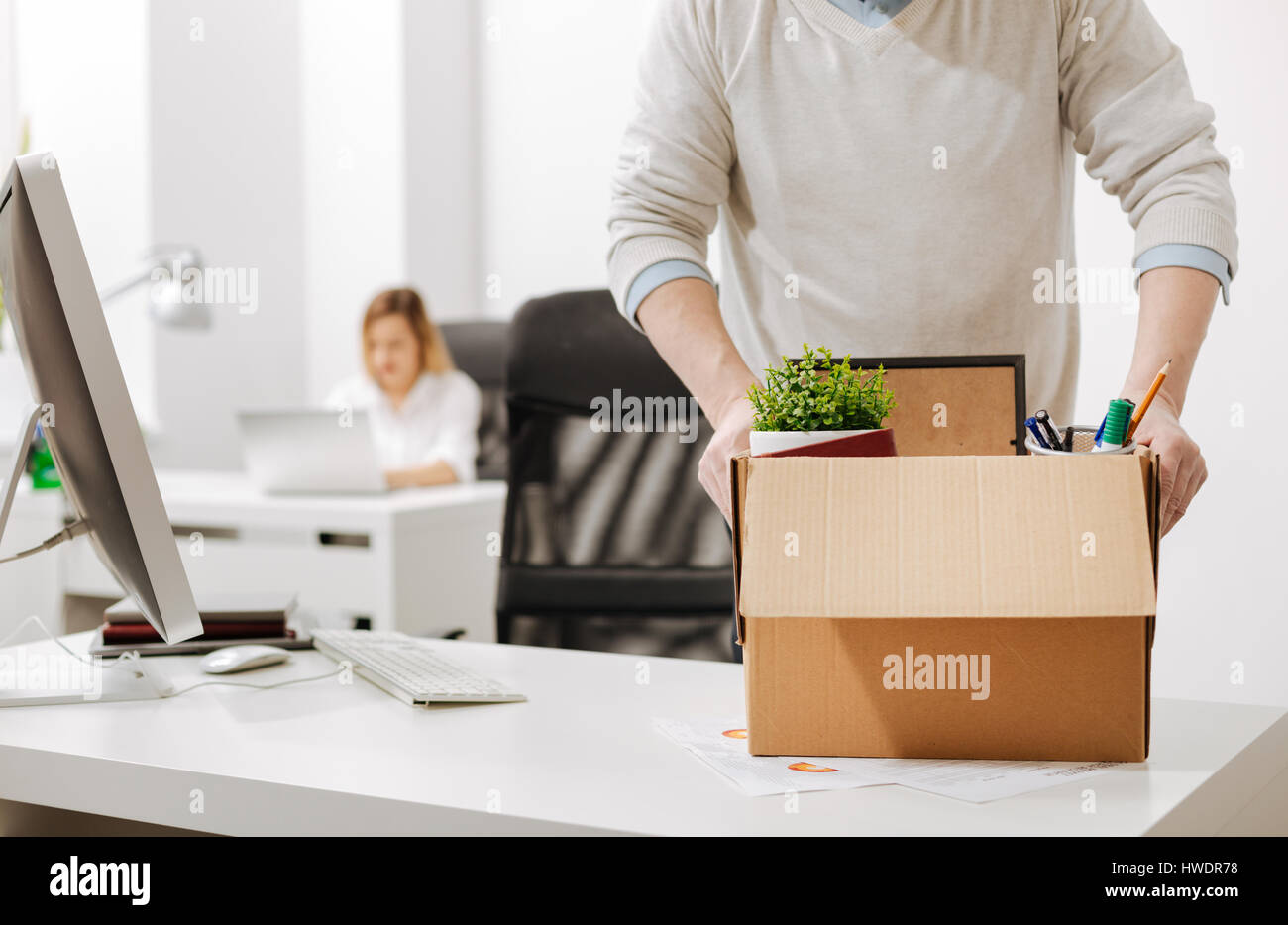 Bemused office manager packing the box and leaving the office Stock ...