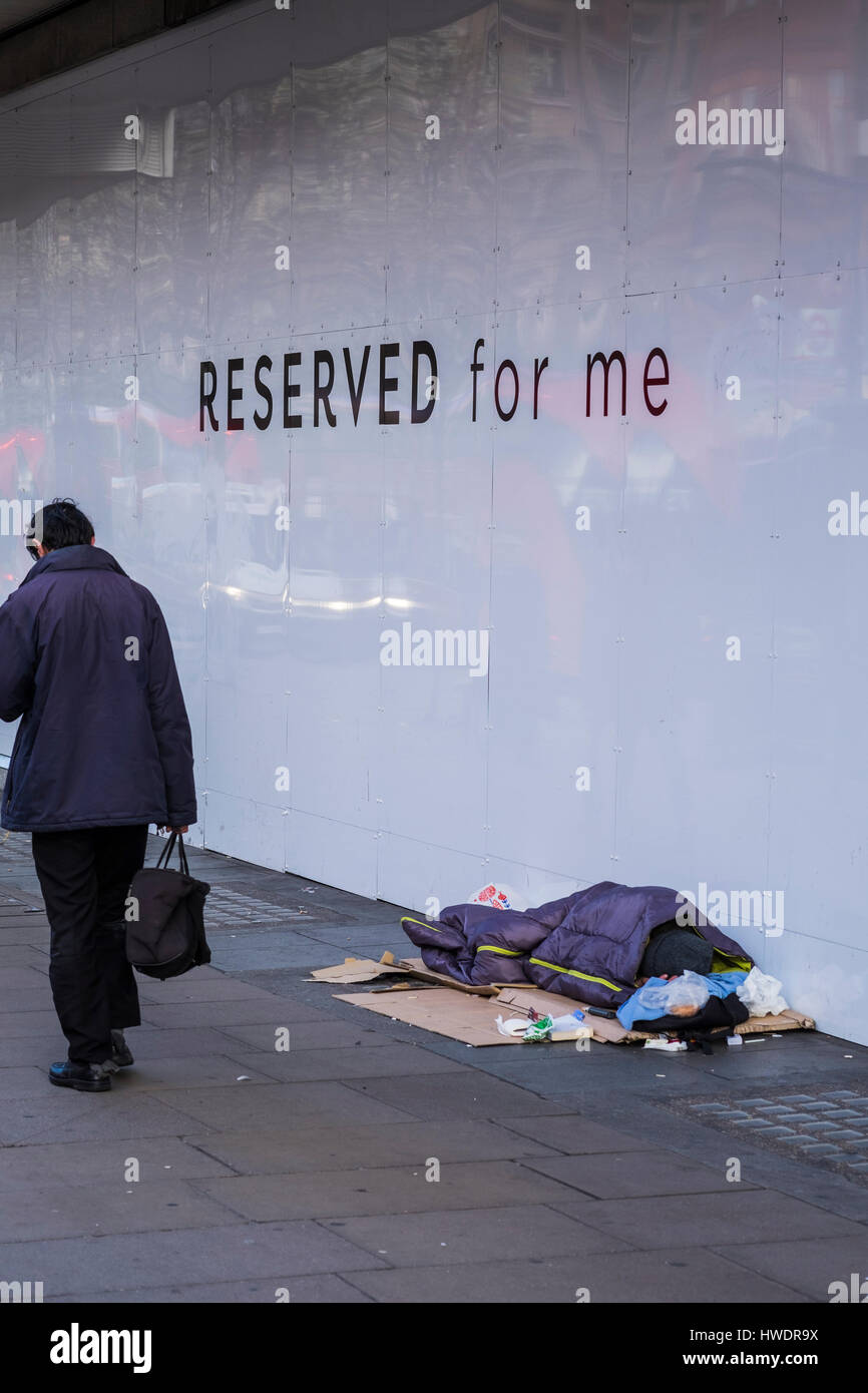 Rough Sleeper in front of boarded up shop front, Oxford Street, London ...
