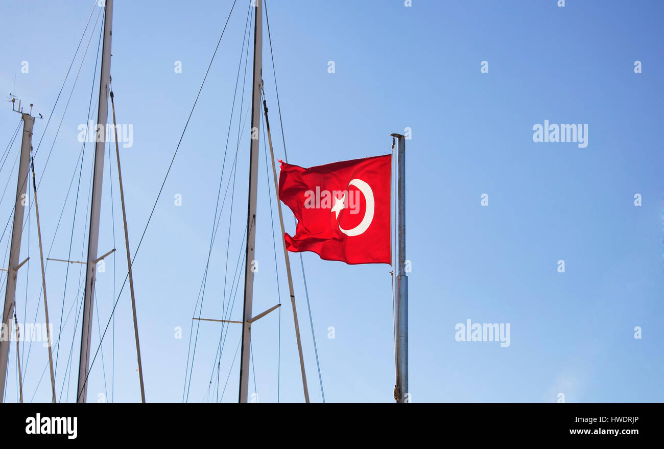 Turkish flag waves with clear blue sky and masts of yachts at marina in ...