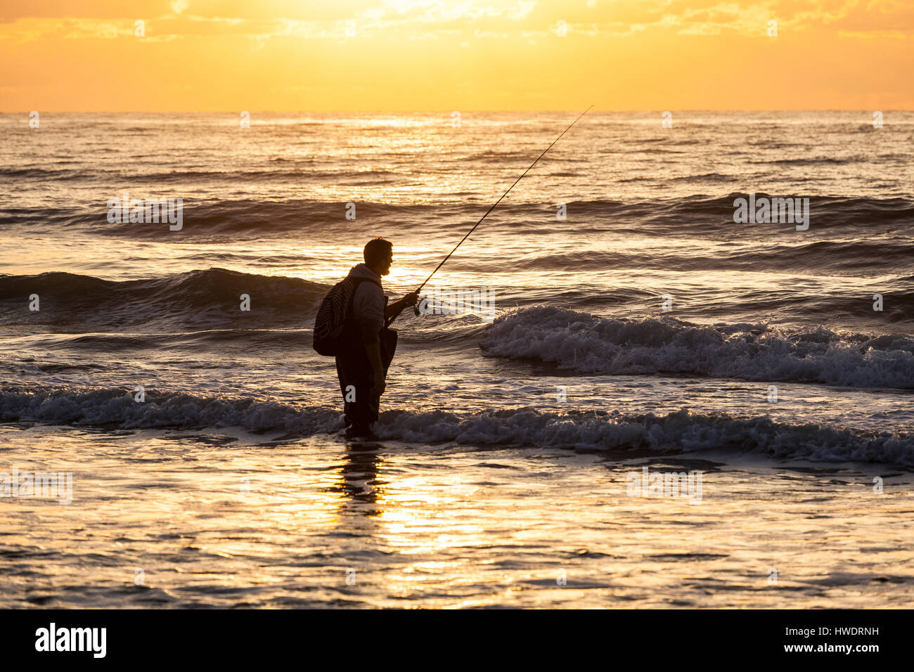 NC00912-00...NORTH CAROLINA - Surf fishing during sunrise over the ...