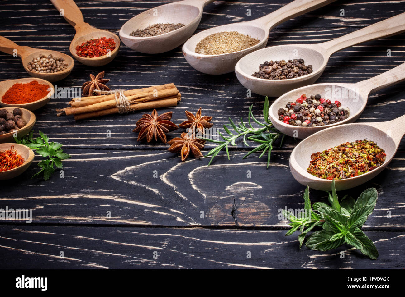 Colorful aromatic spices and herbs on an old oak wooden brown ...