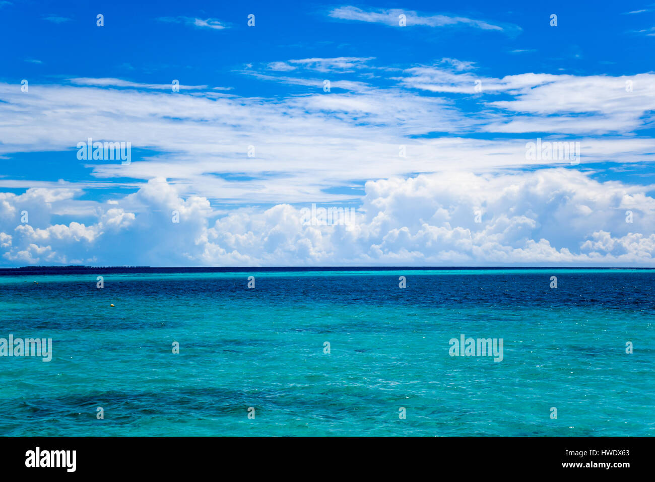 Beautiful turquoise and dark blue seascape with white clouds and lovely ...