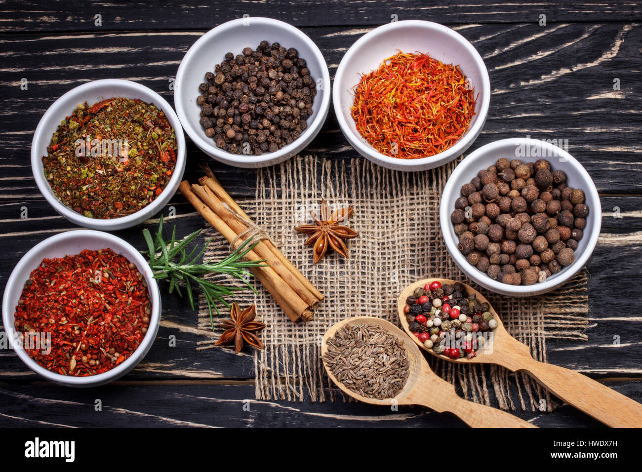 Colorful aromatic spices and herbs on an old oak wooden brown ...