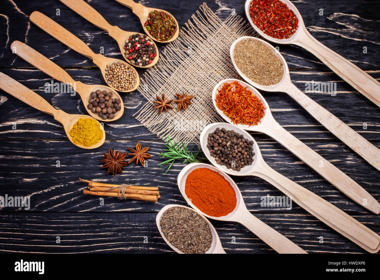 Colorful aromatic spices and herbs on an old oak wooden brown ...